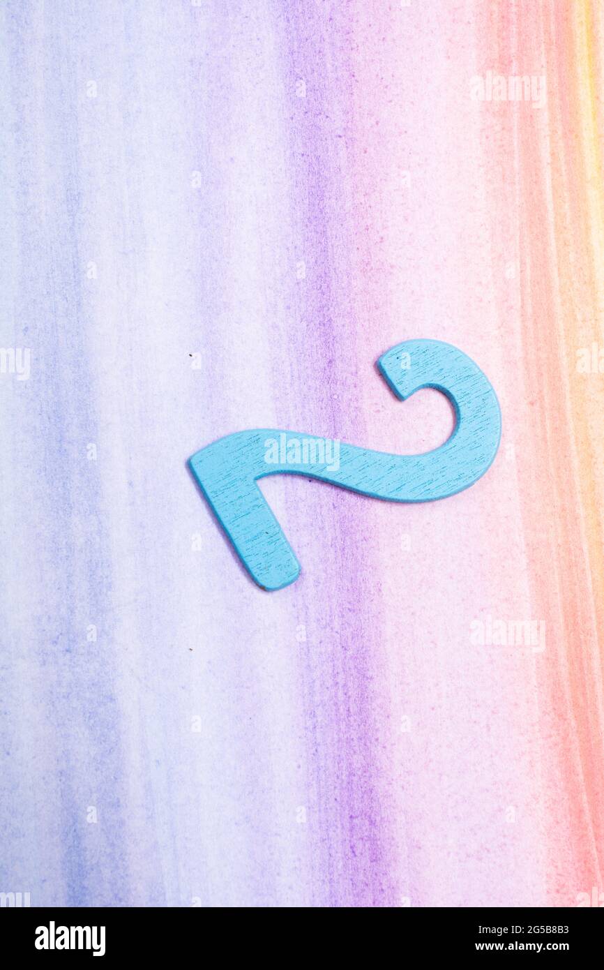 Vertical shot of a wooden number two on a colorful background Stock ...