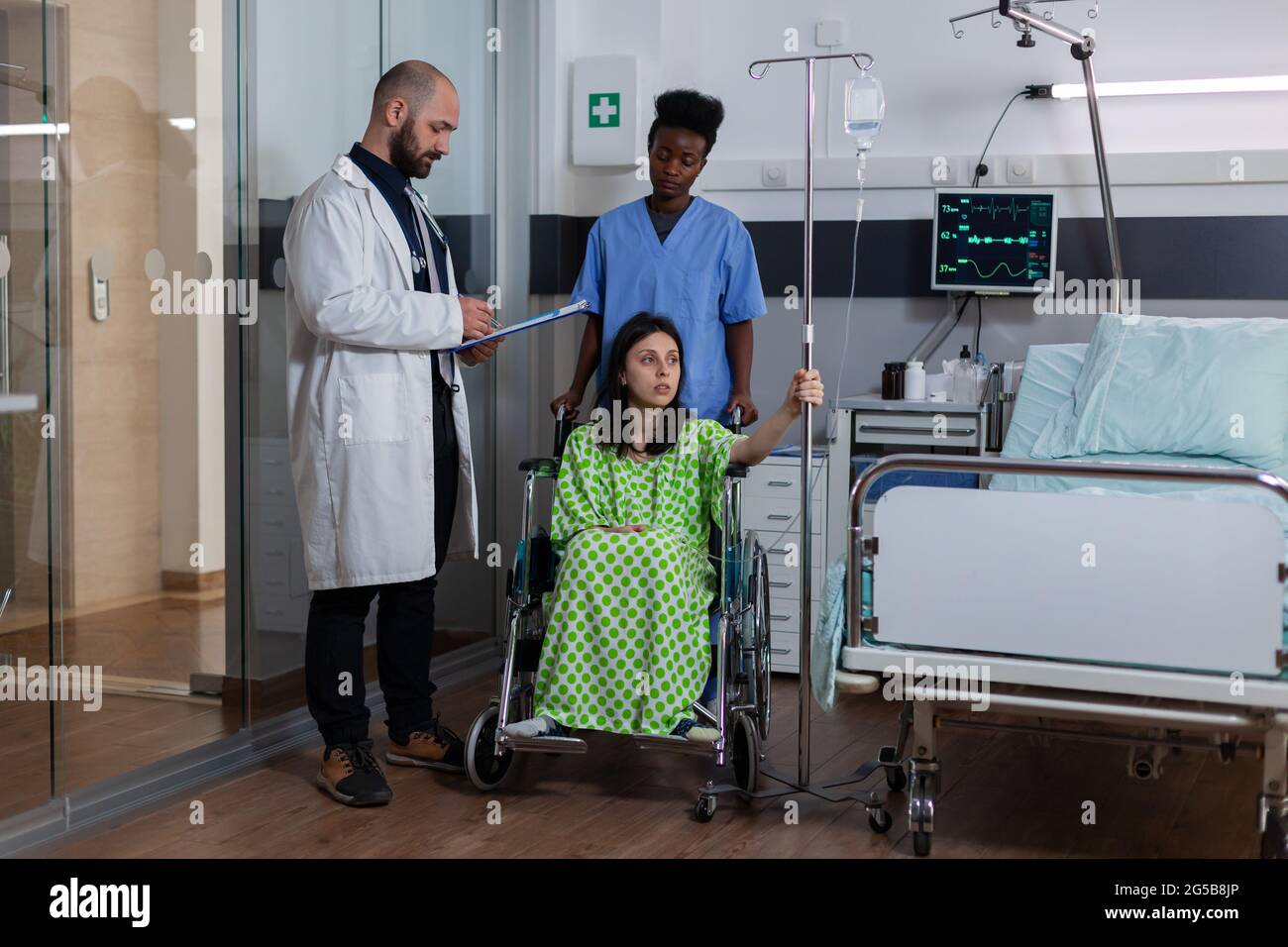 Therapist medic writing disease recovery on clipboard in hospital ward ...