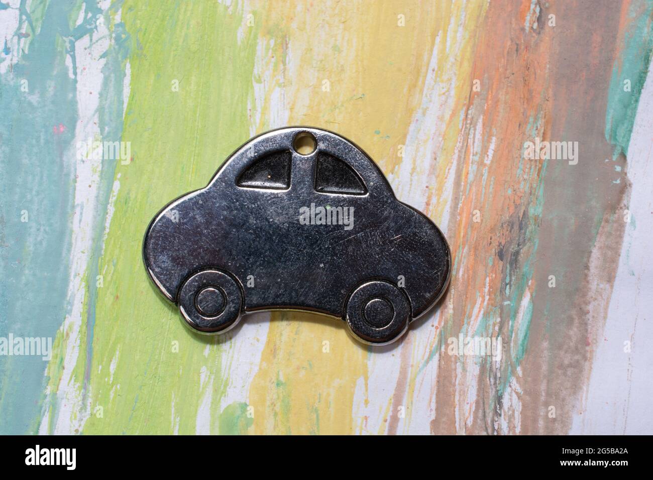 Car-shaped pin on a colorful background Stock Photo - Alamy
