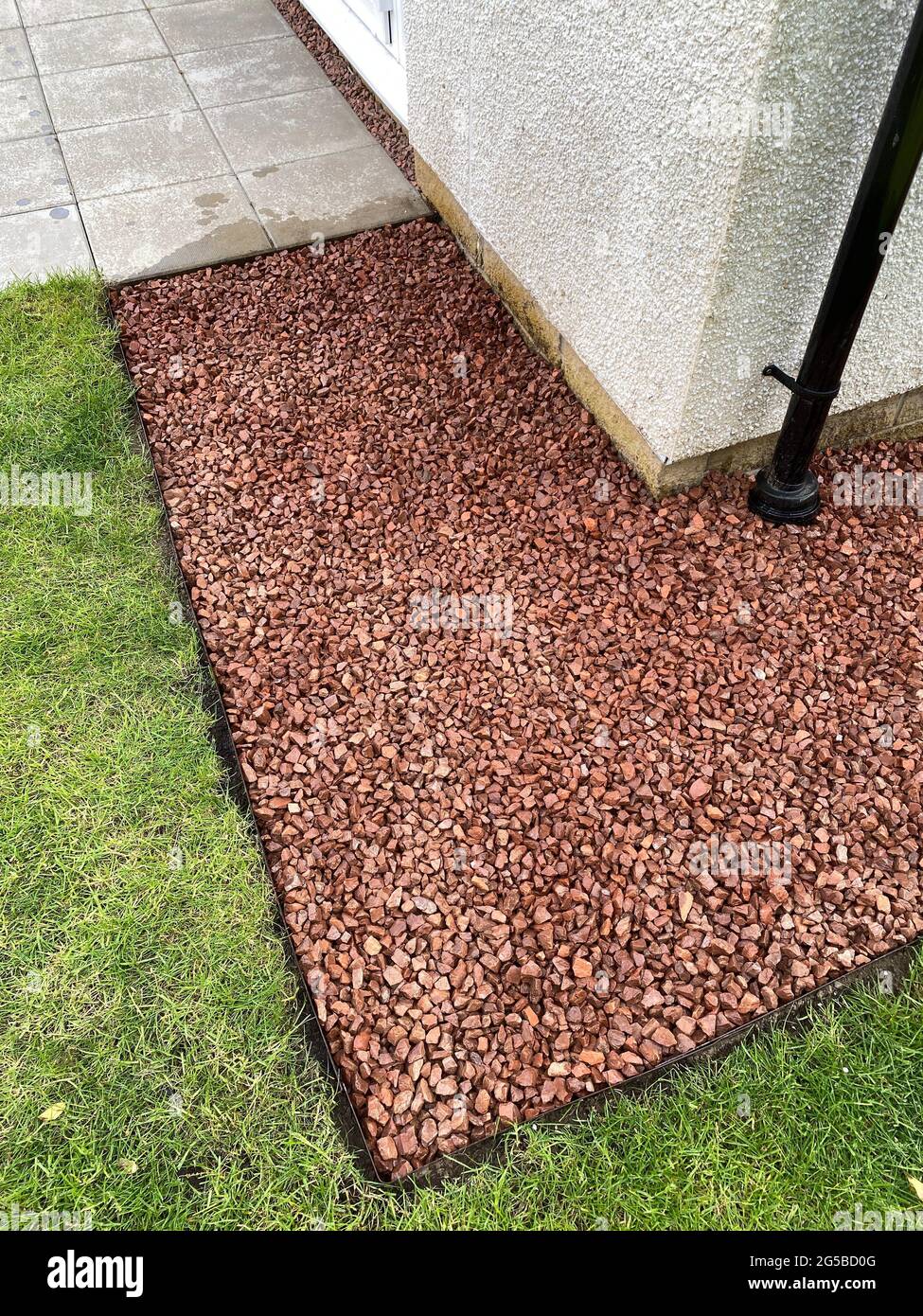 Red stone garden path at back of house Stock Photo - Alamy