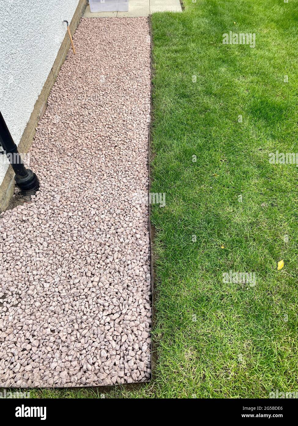 Red stone garden path at back of house Stock Photo - Alamy