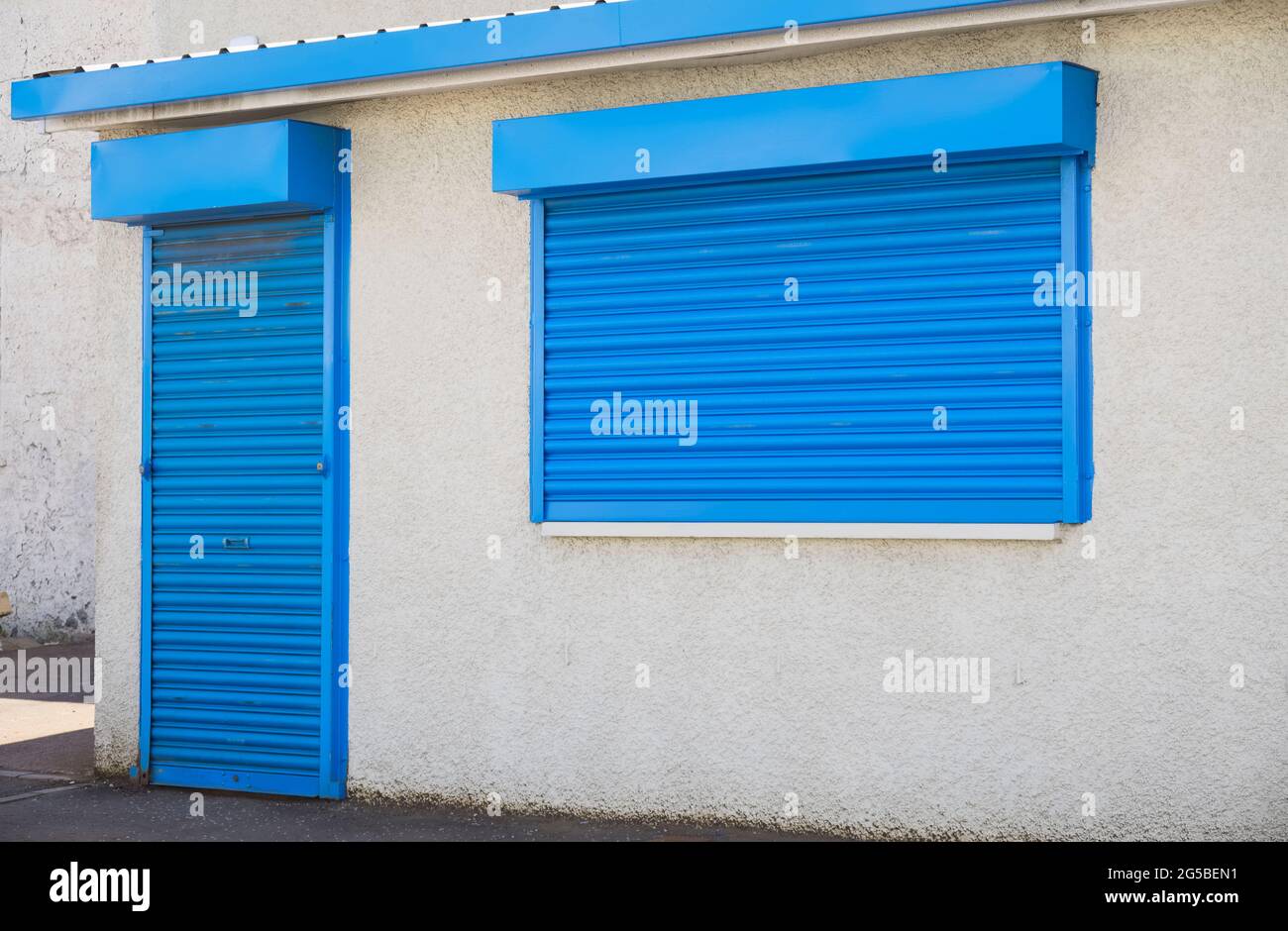 Shop front with blank sign and closed shutter door Stock Photo - Alamy