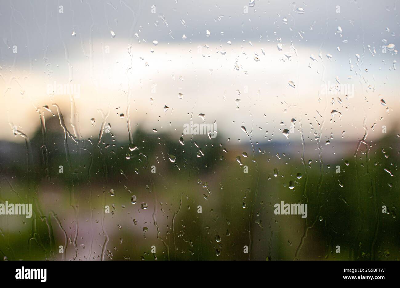 Rainy day through the window on sky and city buildings background Stock ...