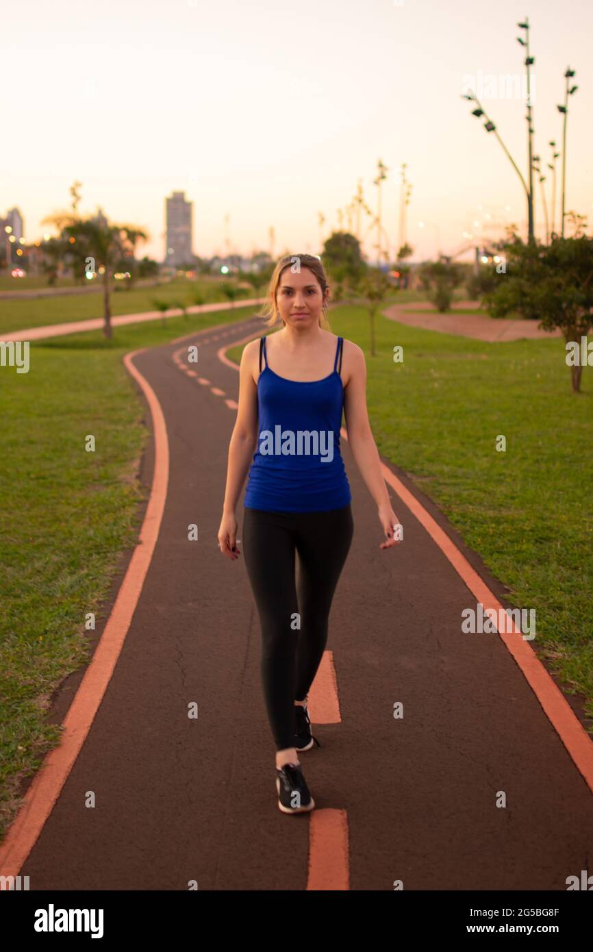 Vertical shot of a Hispanic fit female posing on a running track Stock ...