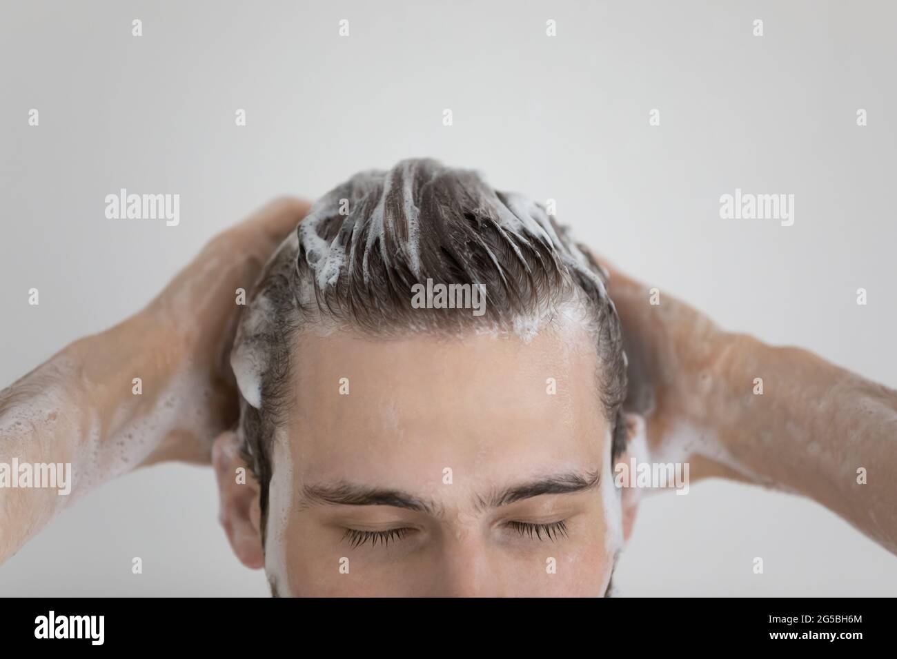 Face of relaxed attractive guy with closed eyes washing head Stock ...