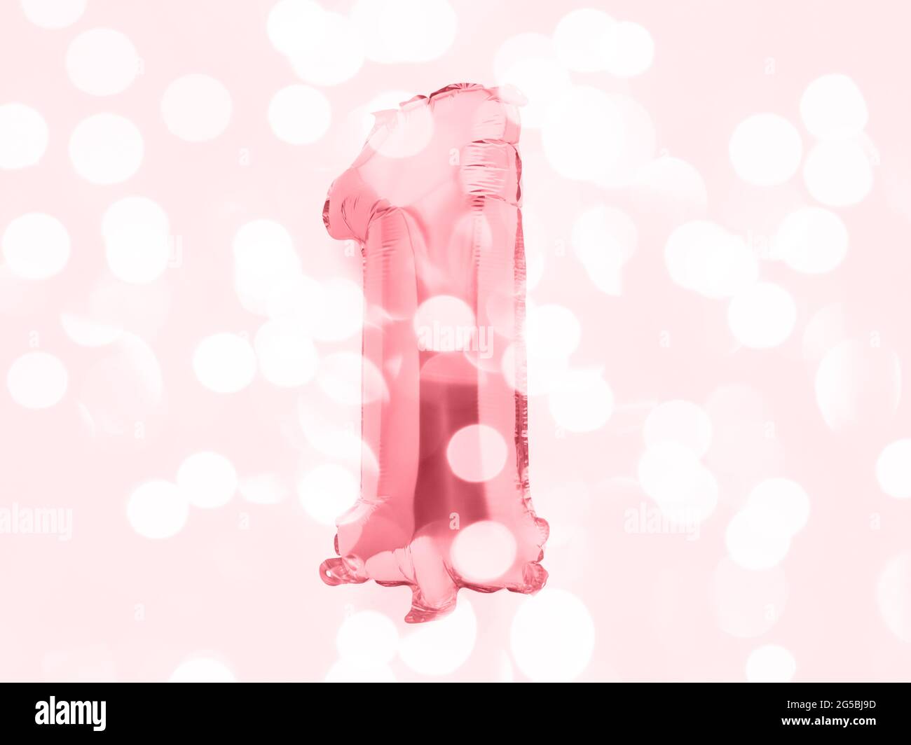 Number 1 rose gold foil balloon party decor on pink background ...