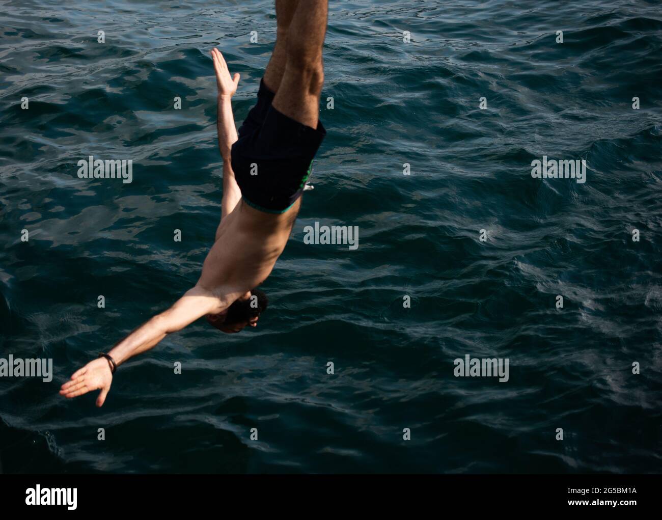 Swimmer jumping into the water Stock Photo - Alamy