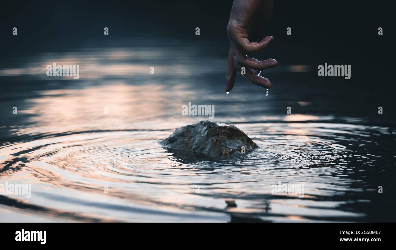 Human hand touching water surface Stock Photo - Alamy
