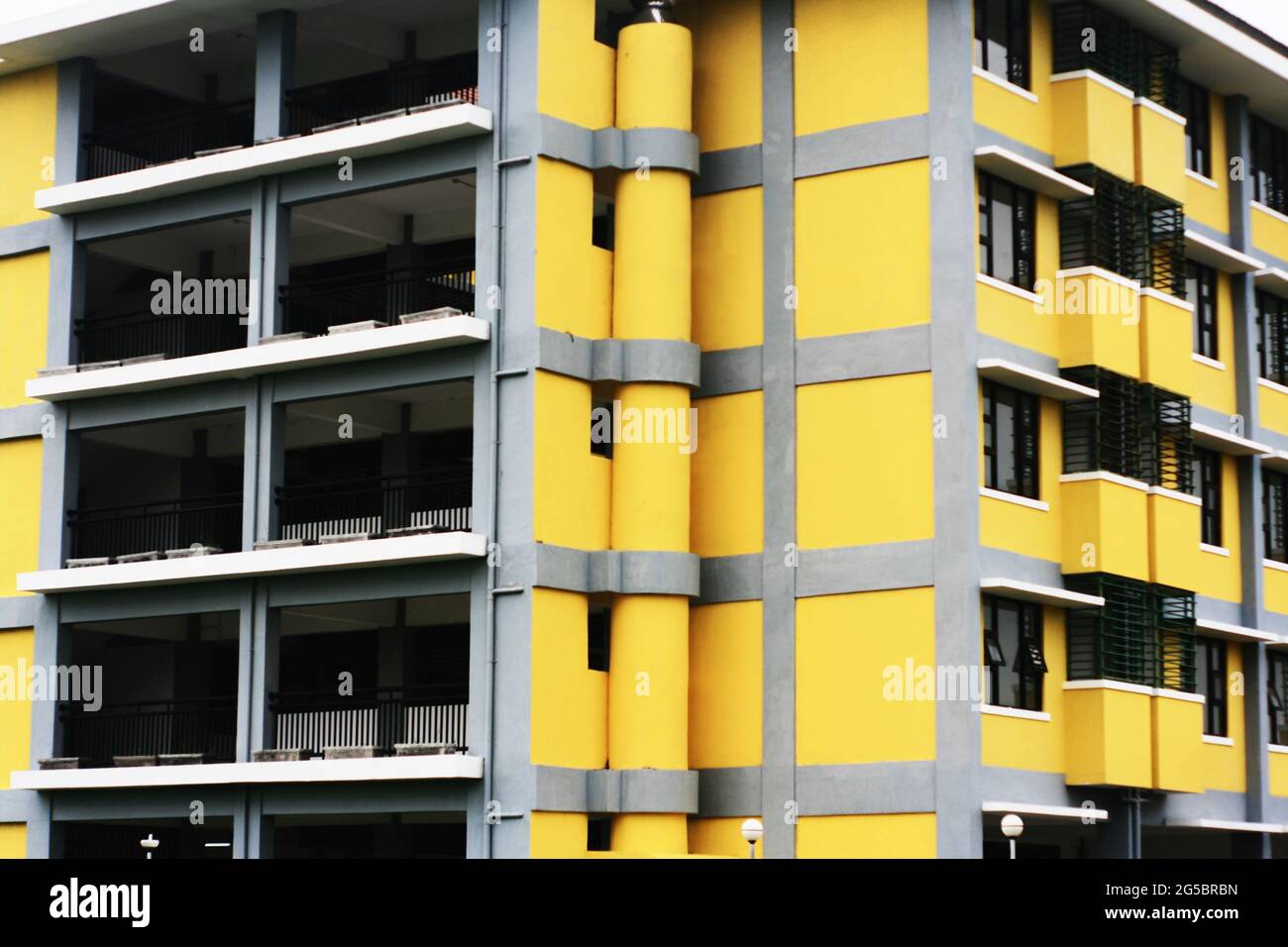 Yellow-black building facade with balconies Stock Photo - Alamy