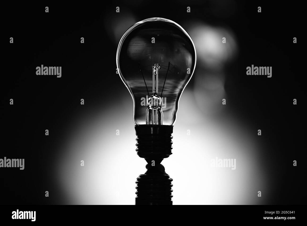 Light bulb on black background Stock Photo - Alamy