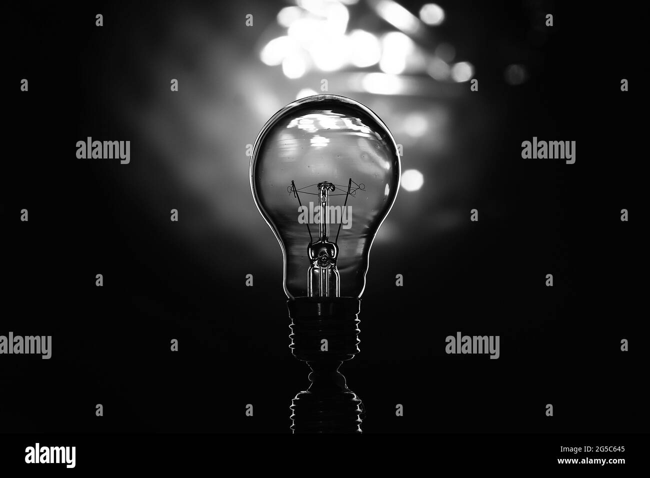 Light bulb on black background Stock Photo - Alamy