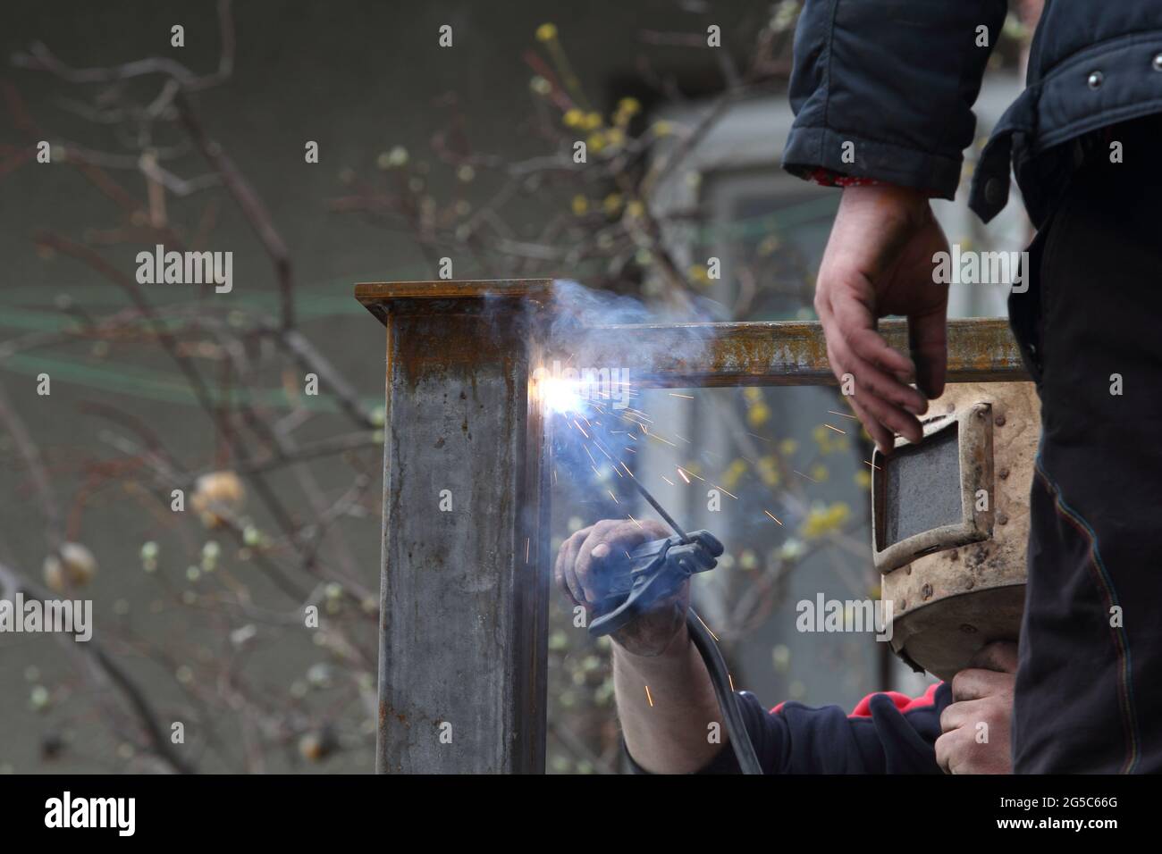 welder worker welding metal. Bright electric arc and sparks Stock Photo ...