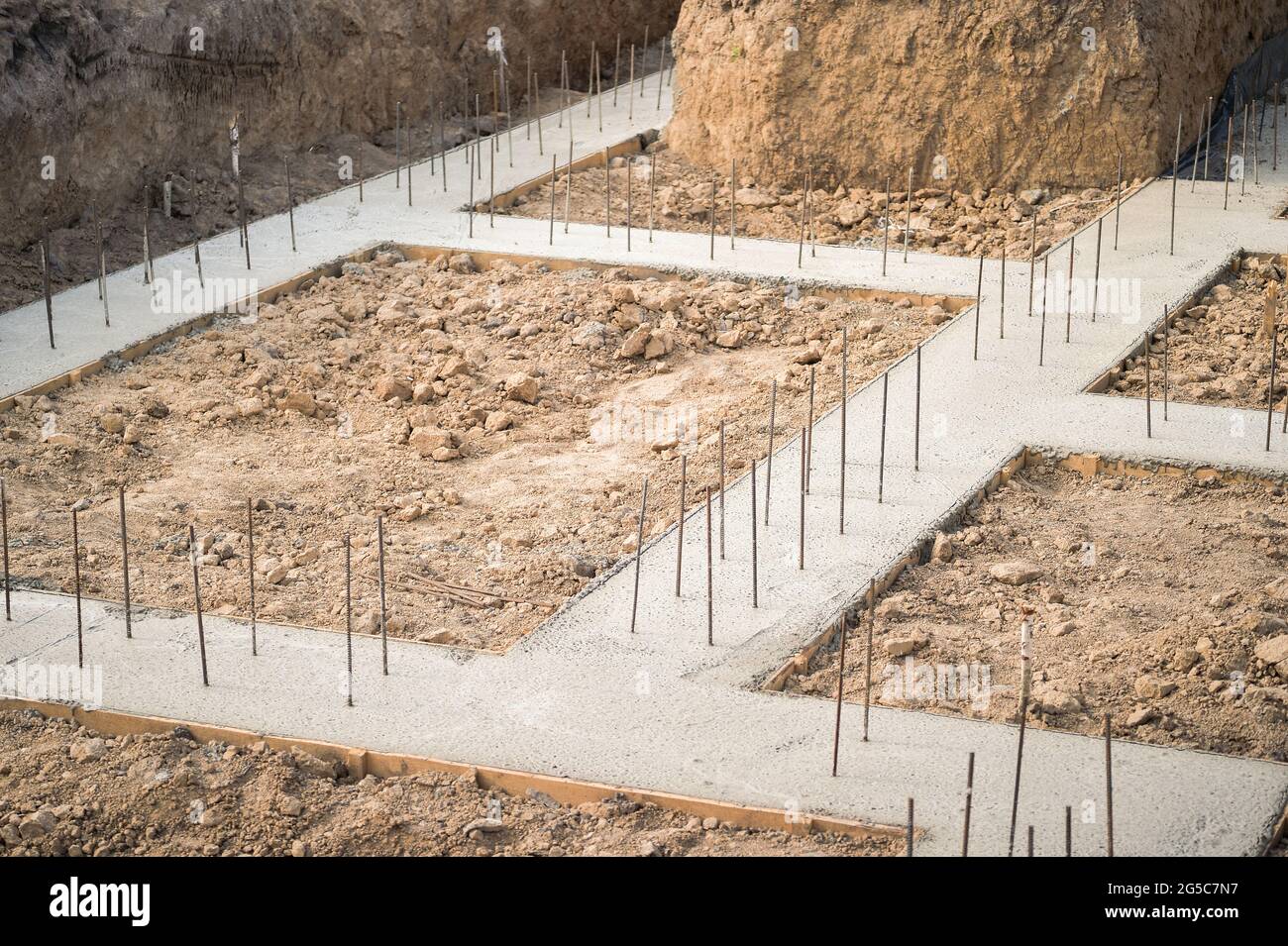 Pouring a concrete solution of the foundation of the construction of a ...
