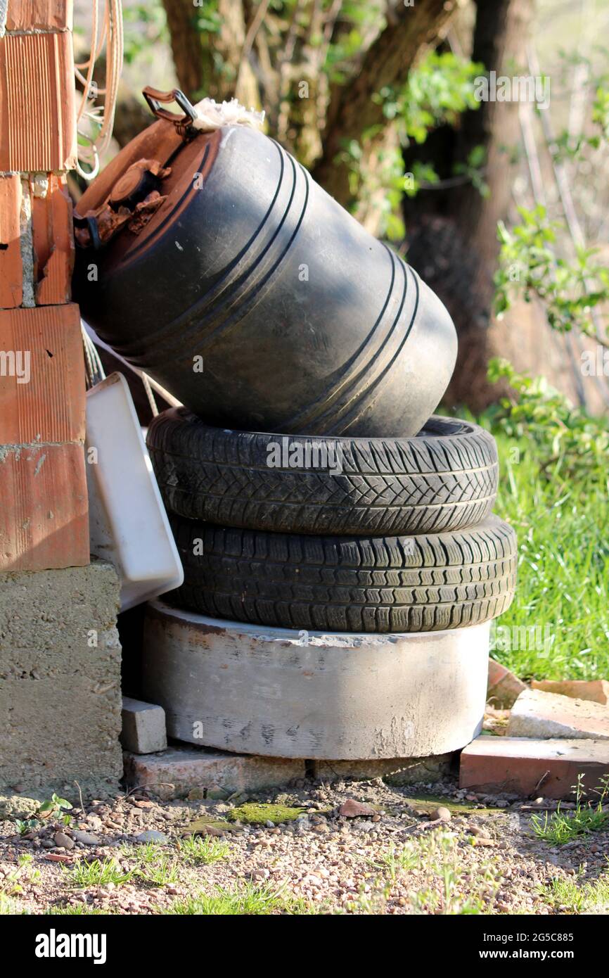 Pile of junk in form of old car tyres mixed with construction material ...