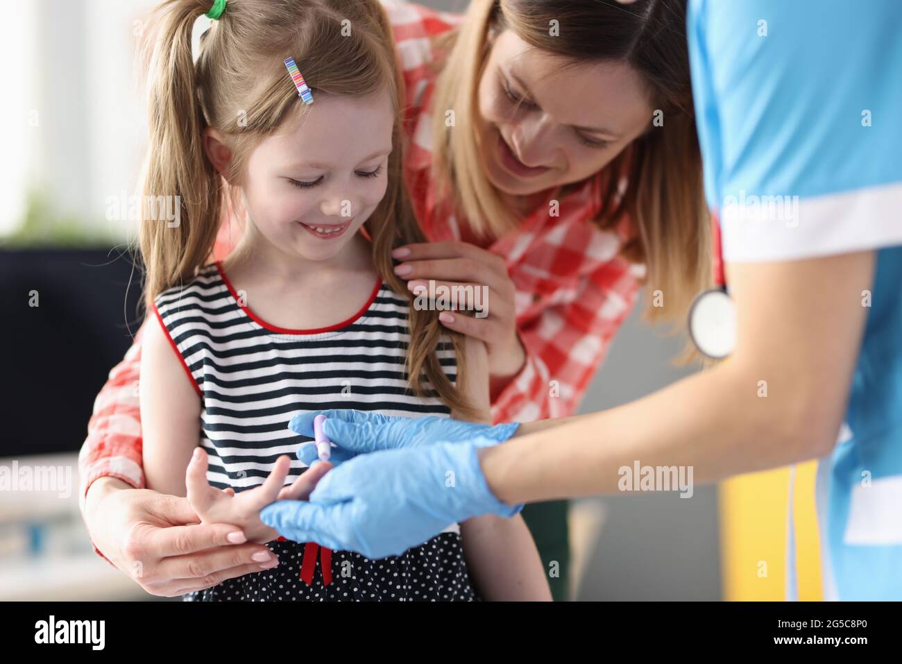 Pediatrician doctor takes blood test from little girl closeup Stock ...