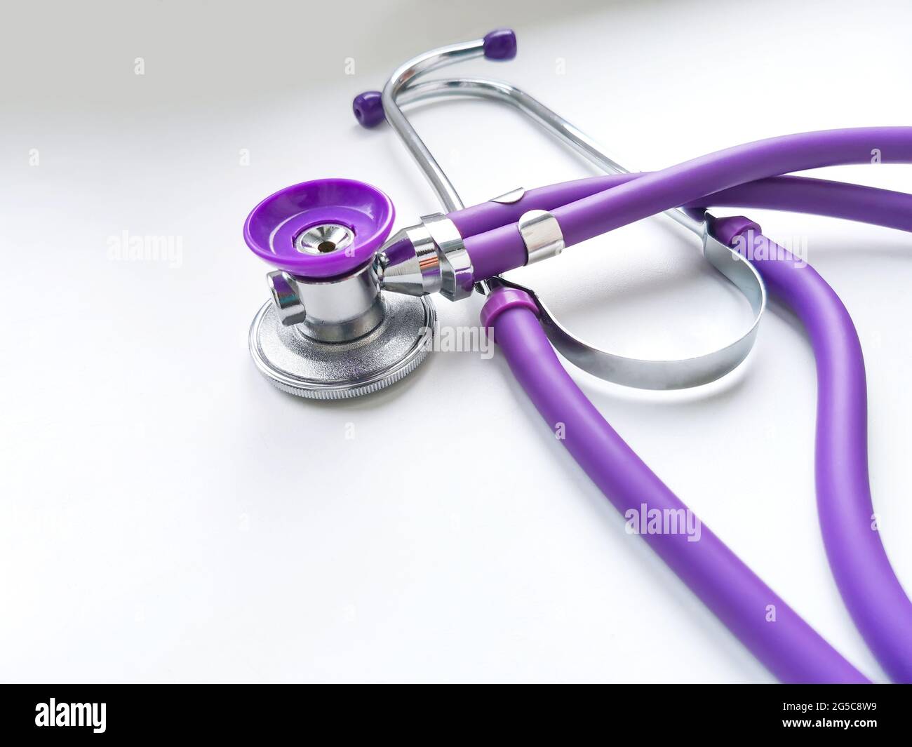 Lilac medical phonendoscope close up on white background - side view ...