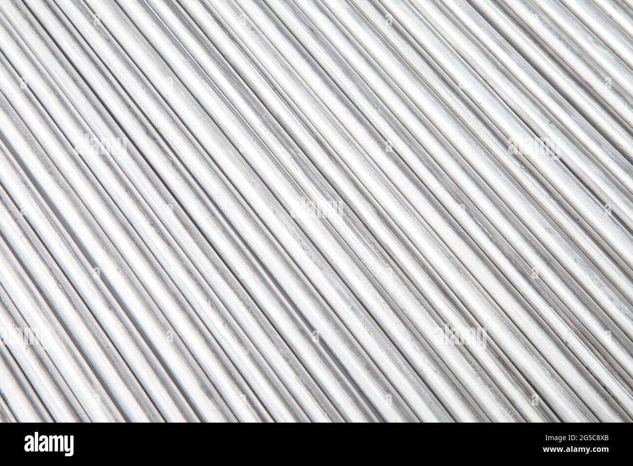 Striped shiny round steel bars Stock Photo - Alamy