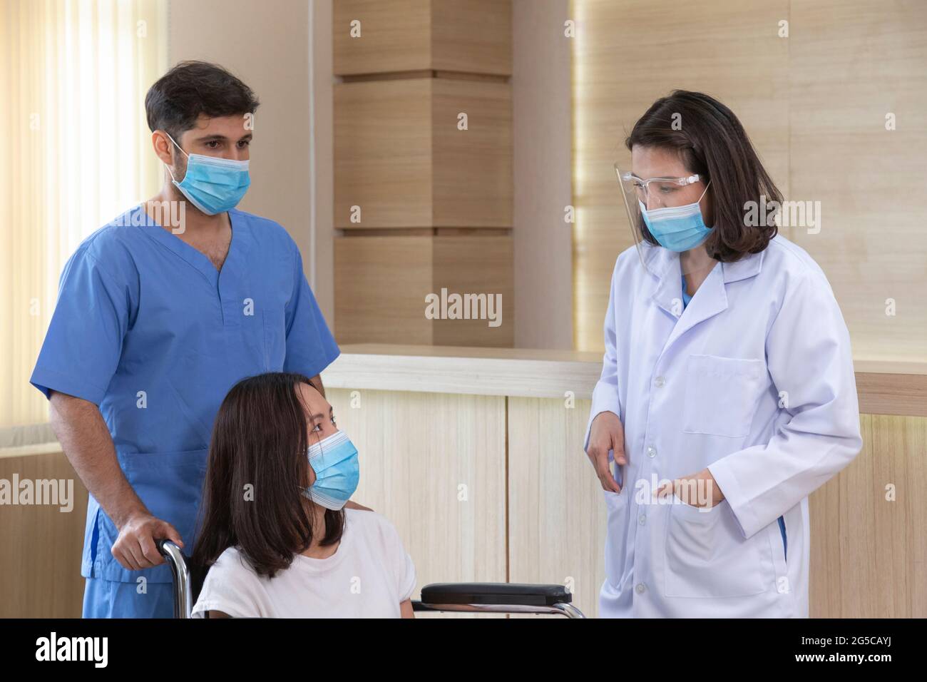 asian female doctor with male nurse wearing protective face mask ...