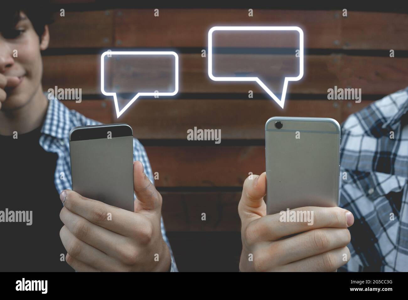 two people holding smartphones and chatting with each other. global ...