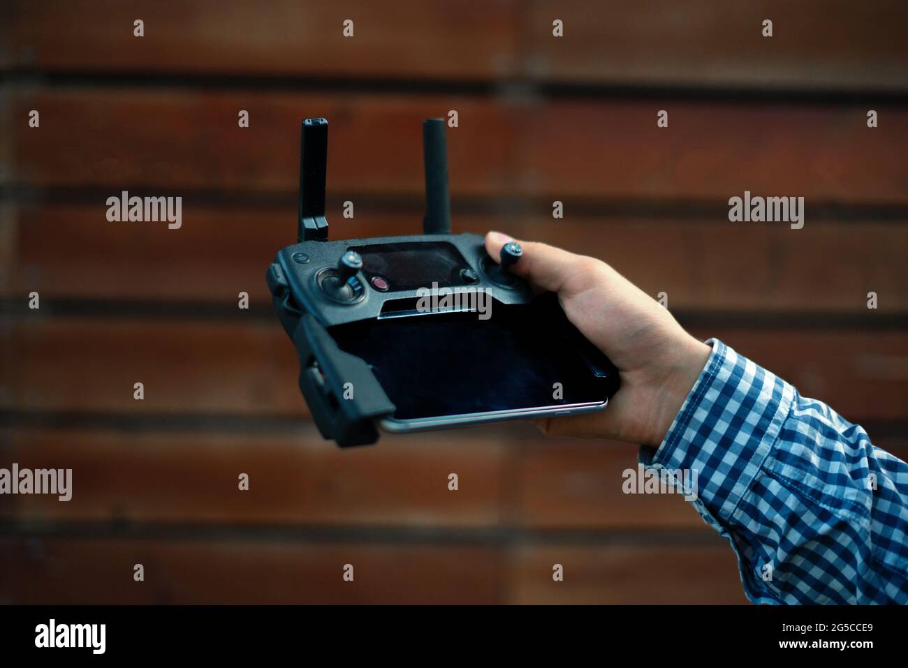 person holding a wireless gadget remote control with joystick and ...