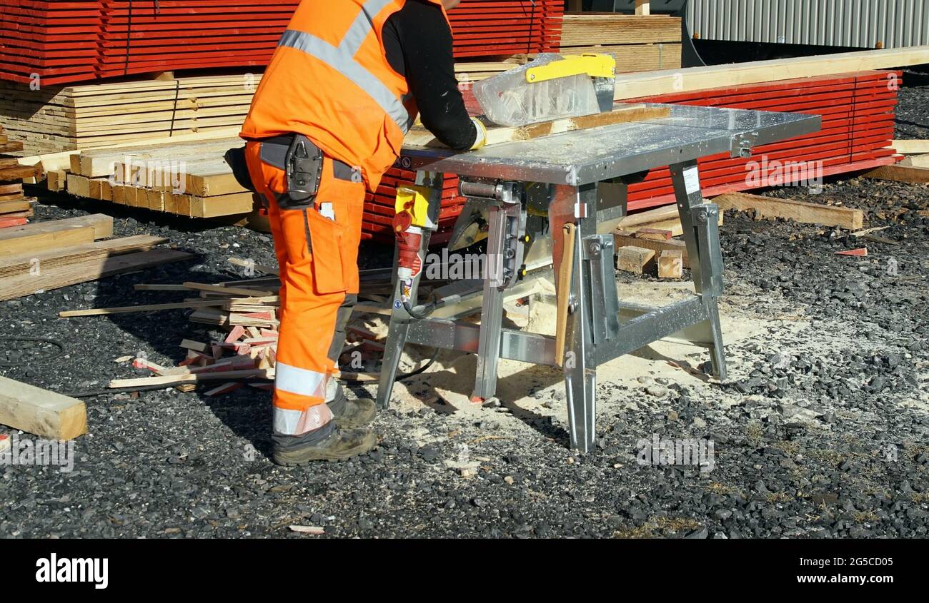 Worker sawing wood on a table saw Stock Photo - Alamy