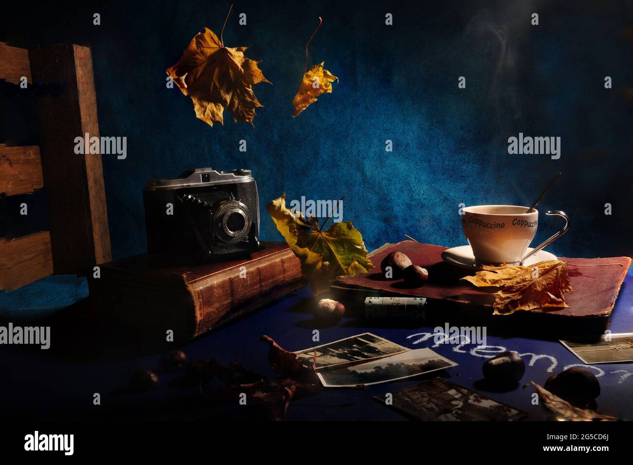 Falling leaves over a beautiful vintage setting on a dark blue ...
