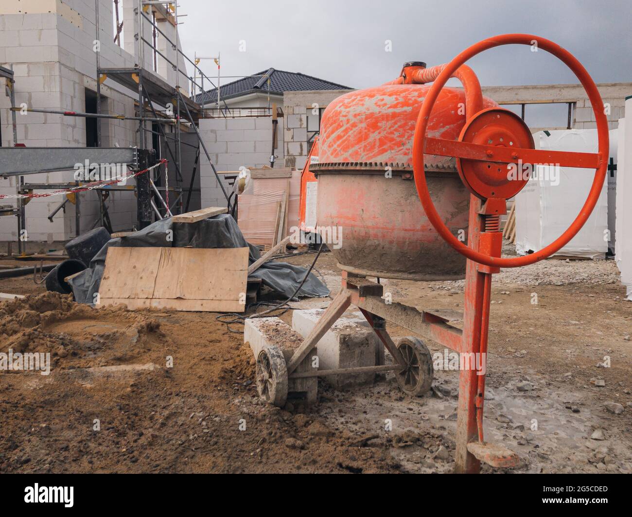 Red manual cement mixer in a construction site Stock Photo - Alamy
