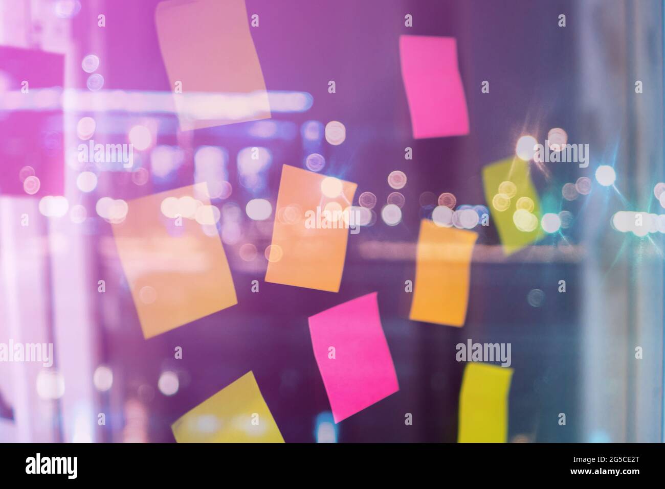 close up color paper stickers for notes on the window glass in the dark ...
