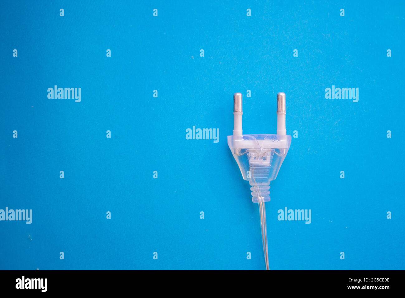 White electric plug on the blue background with copy space Stock Photo ...