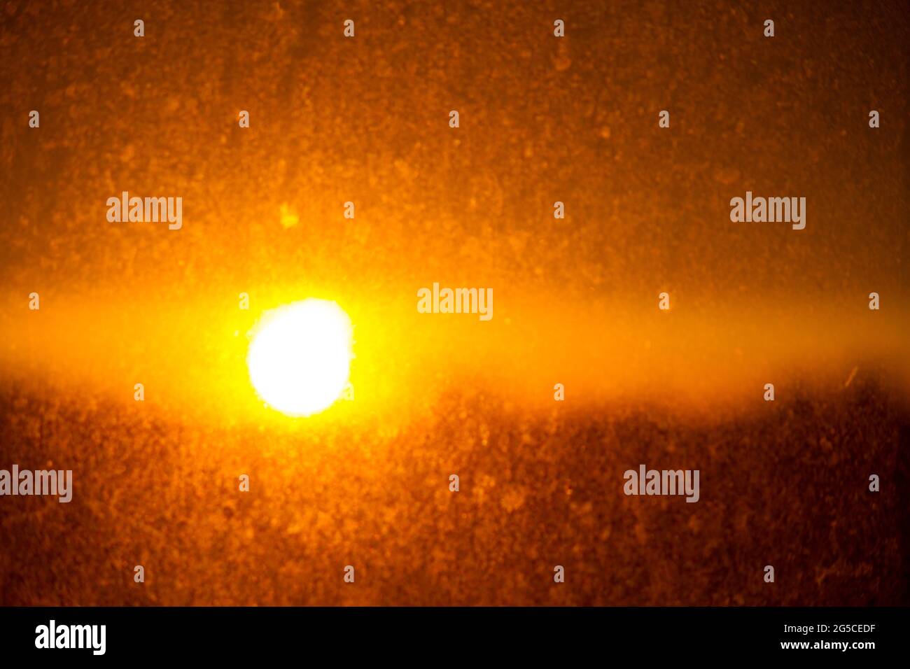 Sun sets over a city. Blurred image Stock Photo - Alamy