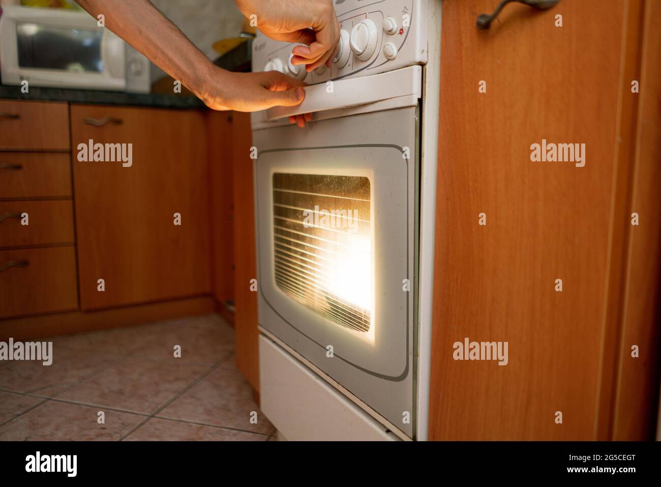 opening the gas oven in the kitchen while baking and cooking Stock ...