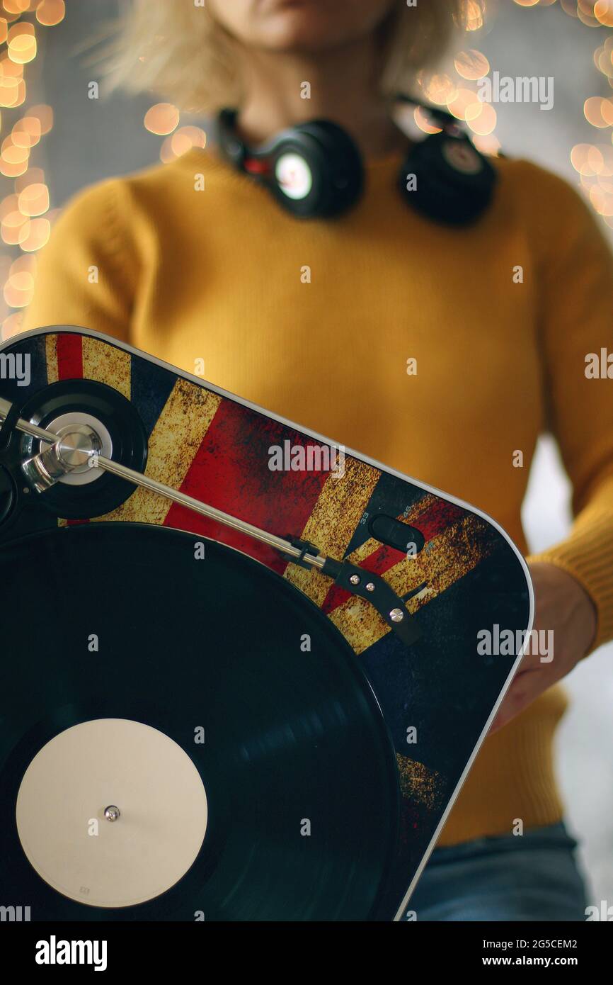 Girl hold a turntable. Music concept and background Stock Photo - Alamy