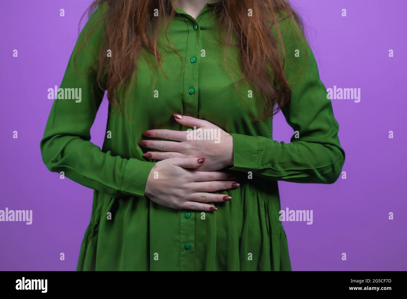 Woman squeezing belly with hands because of abdominal pain. Lady ...
