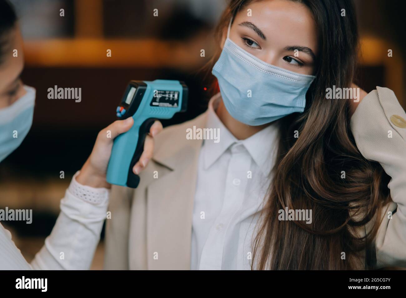 Measuring body temperature with contactless body thermometer Stock ...