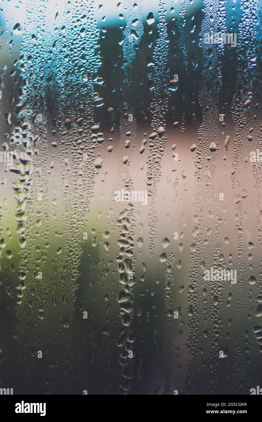 water droplets of humidity condensation on window seen from indoor with ...