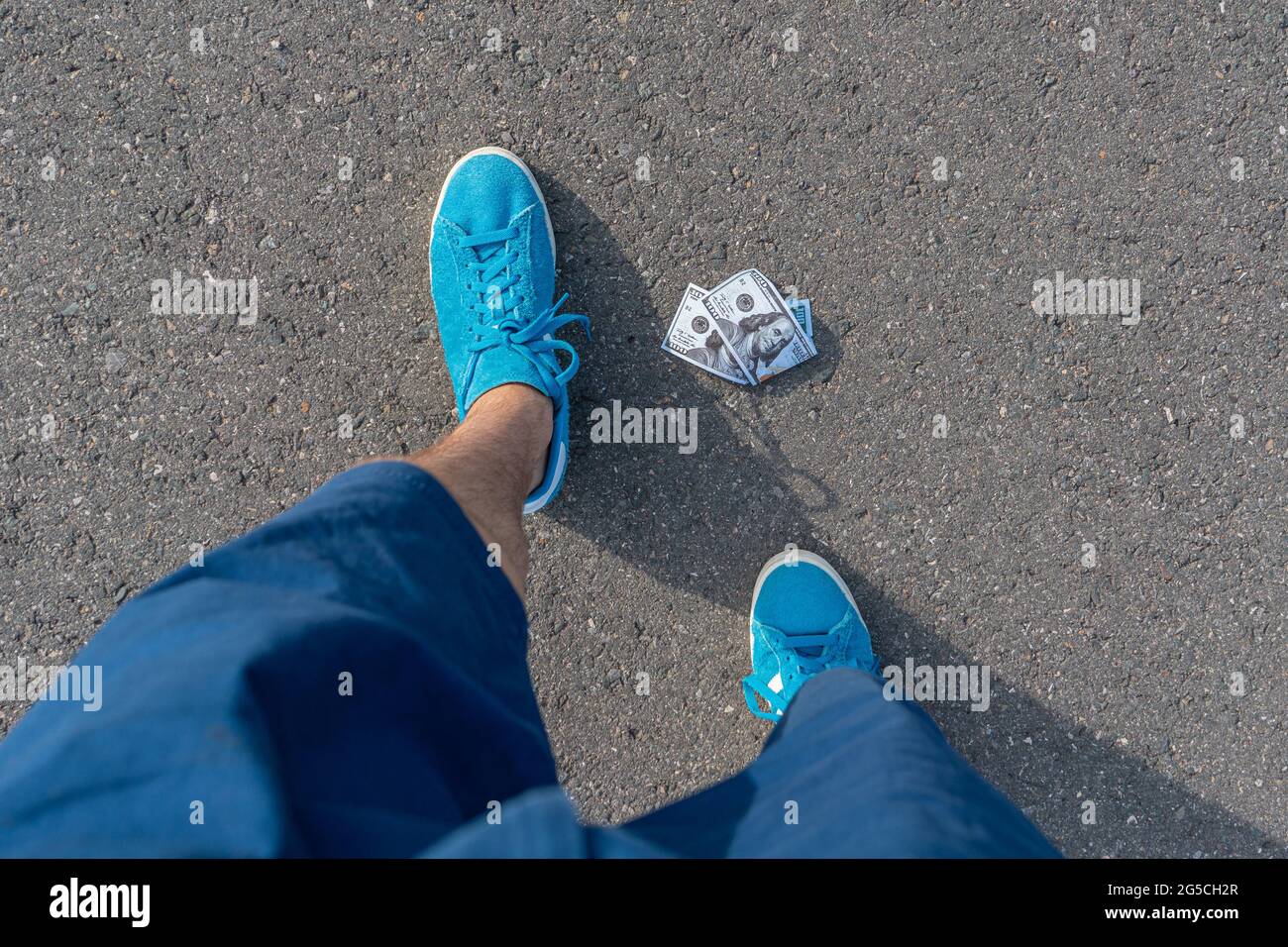 person find paper money lost and dropped on the asphalt ground outdoor ...
