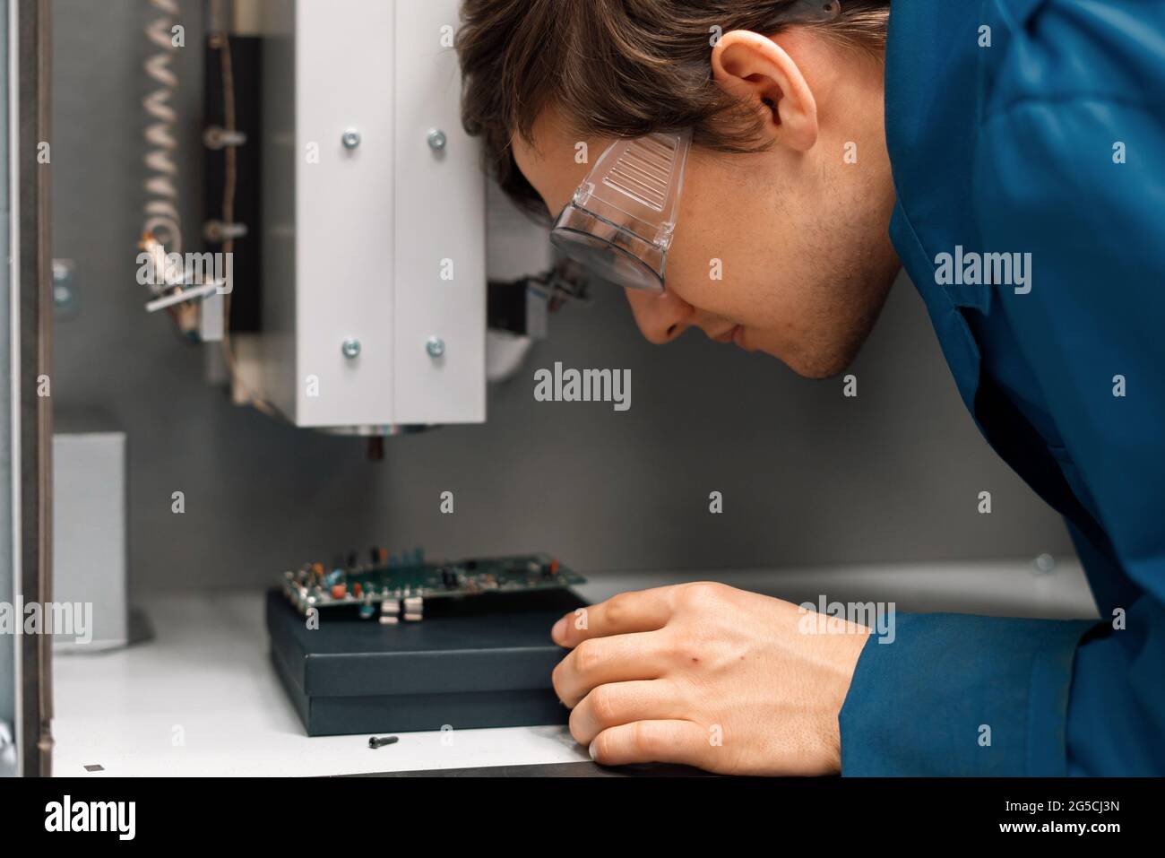 the engineer employee working process on the machine factory Stock ...