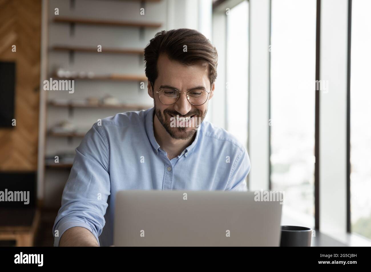 Happy young male entrepreneur reading email with amazing news Stock ...