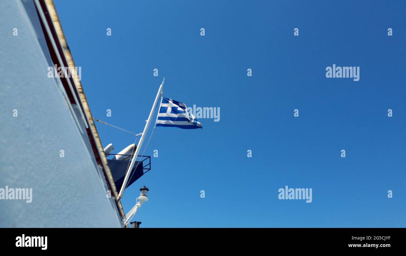 Greek flag waving in the back of a ship in the ocean Stock Photo - Alamy