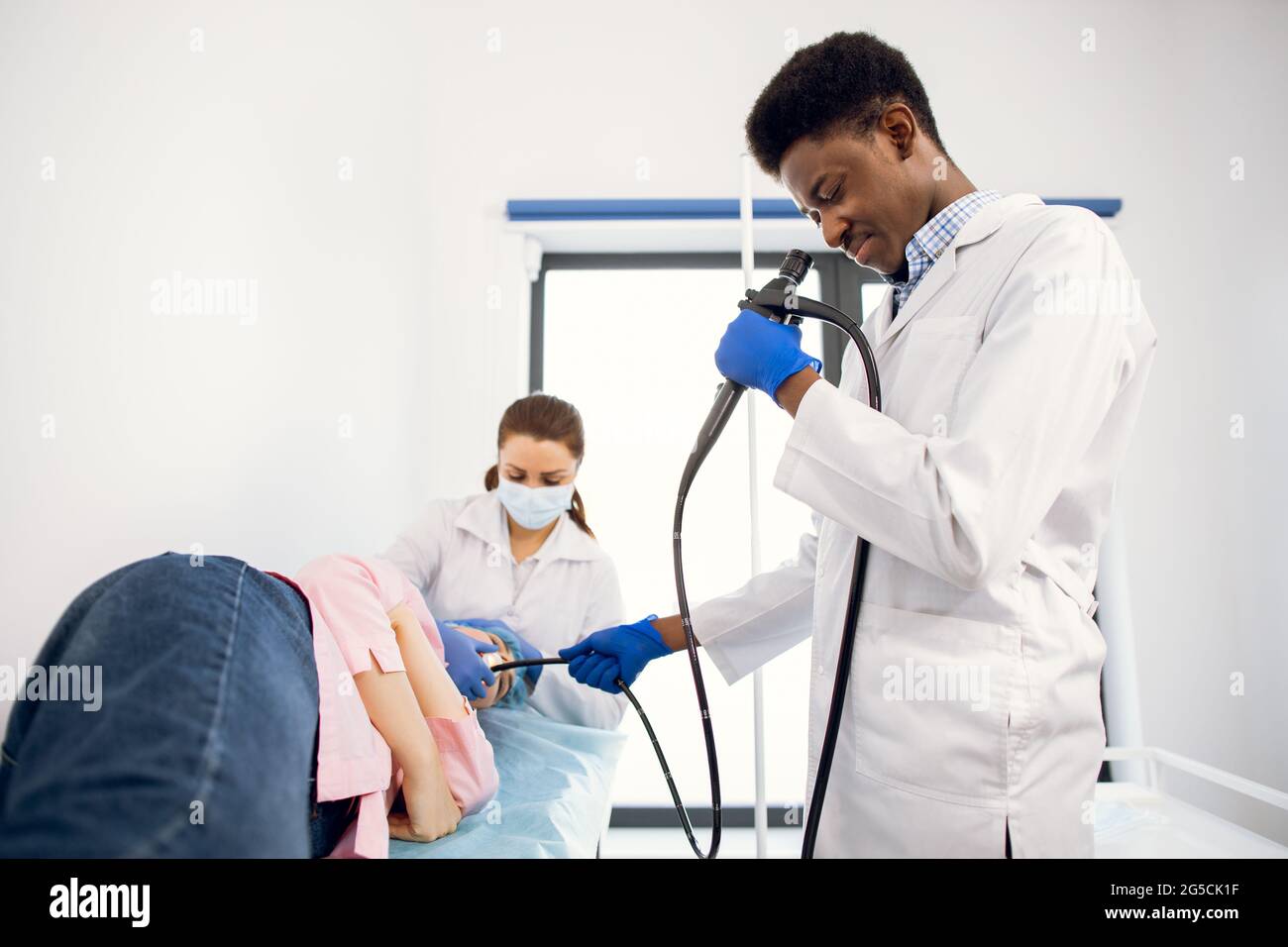Young african american man doctor and female nurse doing endoscopy ...