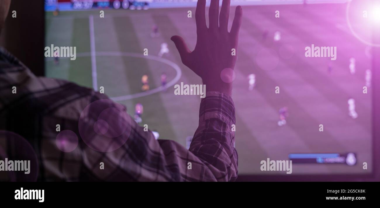 a football of soccer fan cheering for his national team watching the ...