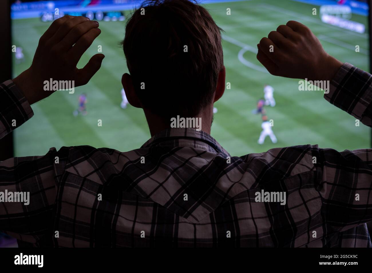 a football of soccer fan cheering for his national team watching the ...