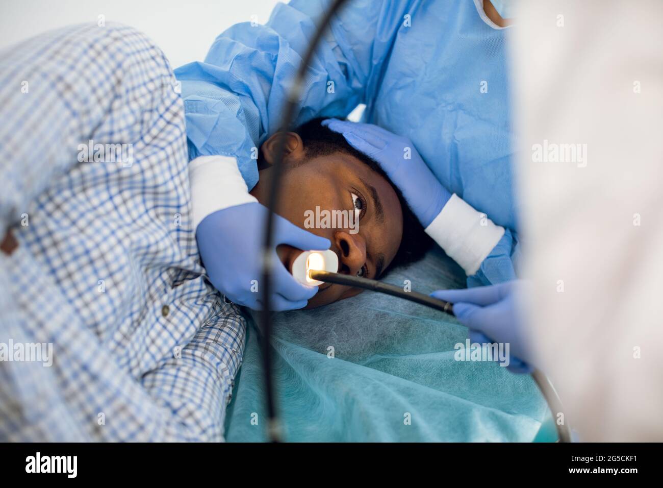Close up cropped shot of young African American male patient, lying on ...