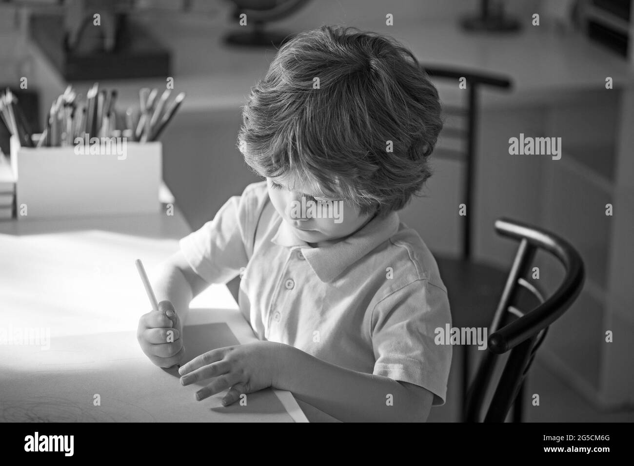 Little boy is playing with pencils indoors Stock Photo - Alamy