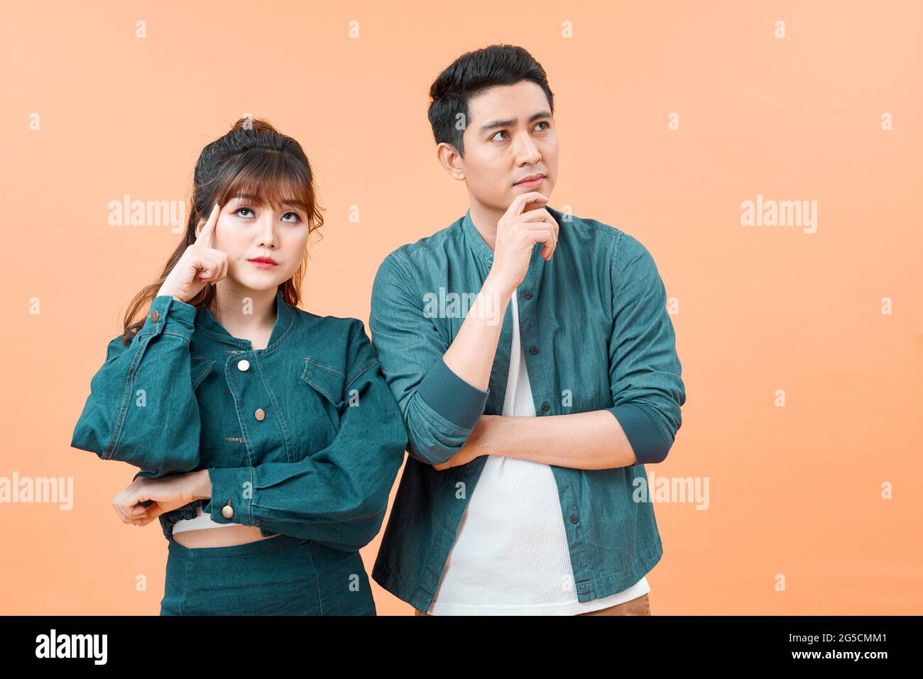 Portrait of pensive loving couple thinking and looking away isolated ...