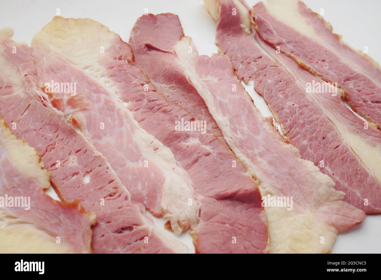detail shot of Raw fed bacon strips on c white background Stock Photo ...