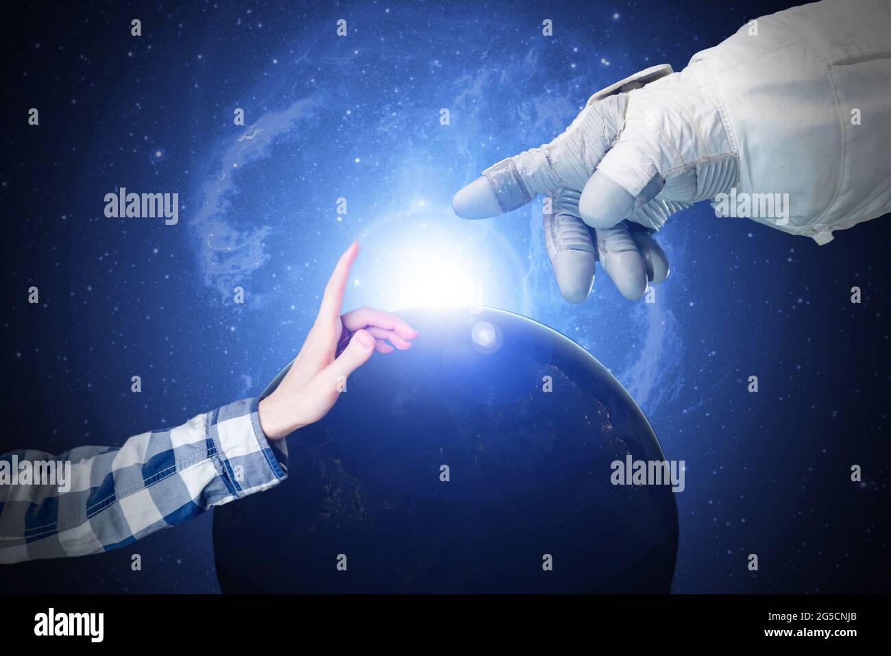 close up the hand of human and the astronaut touch in the outer space ...