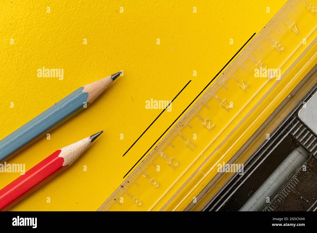 drawing a line on a color surface with a ruler and pencil Stock Photo ...
