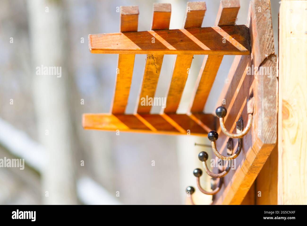 Clothes hooks on a wooden plaque. Outdoor Stock Photo - Alamy