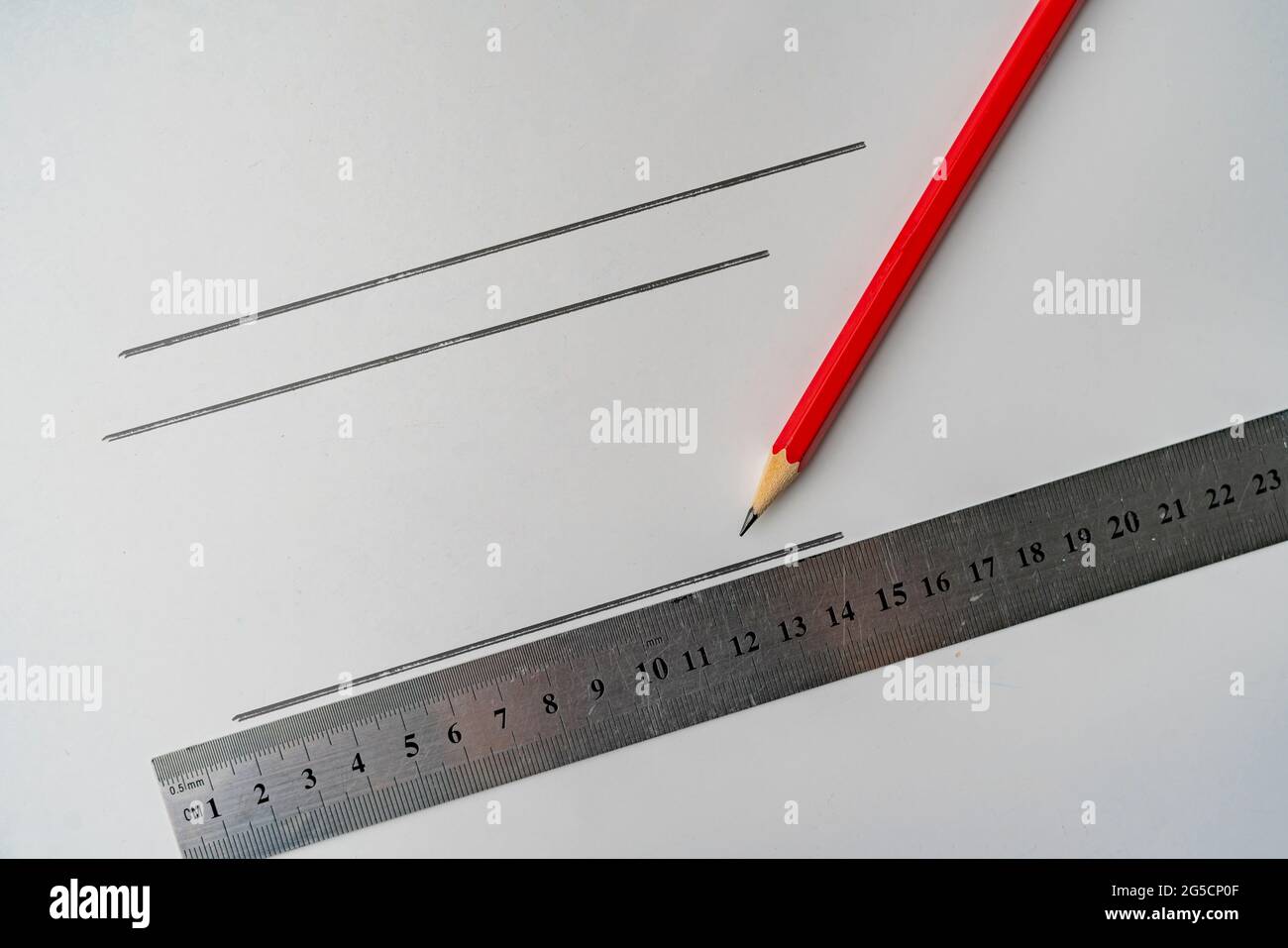 drawing a line on a color surface with a ruler and pencil Stock Photo ...